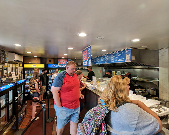 Inside, the organized chaos of lunchtime at John's is a beautiful dance&mdash;customers point, staff slice, and sandwich magic happens before your eyes.