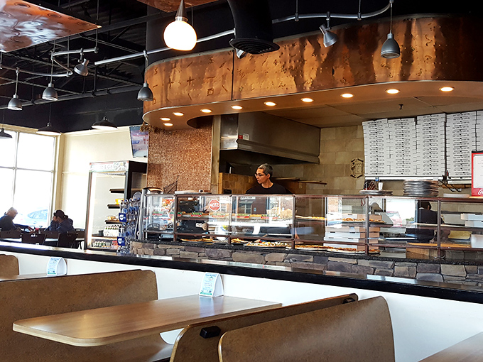 Step inside this culinary theater where open kitchens showcase pizza artistry and fresh ingredients steal every scene.