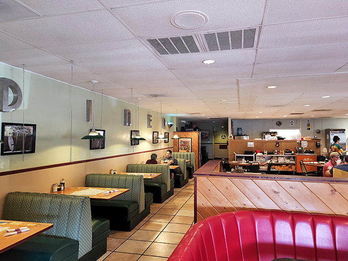 Green vinyl booths and wooden dividers create the quintessential diner experience, where conversations flow as freely as the coffee.