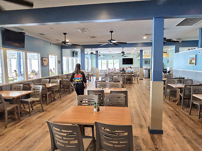 Coastal cool meets casual comfort inside Palm Pavilion's dining room, where sea-blue walls and wooden accents create the perfect post-swim atmosphere.