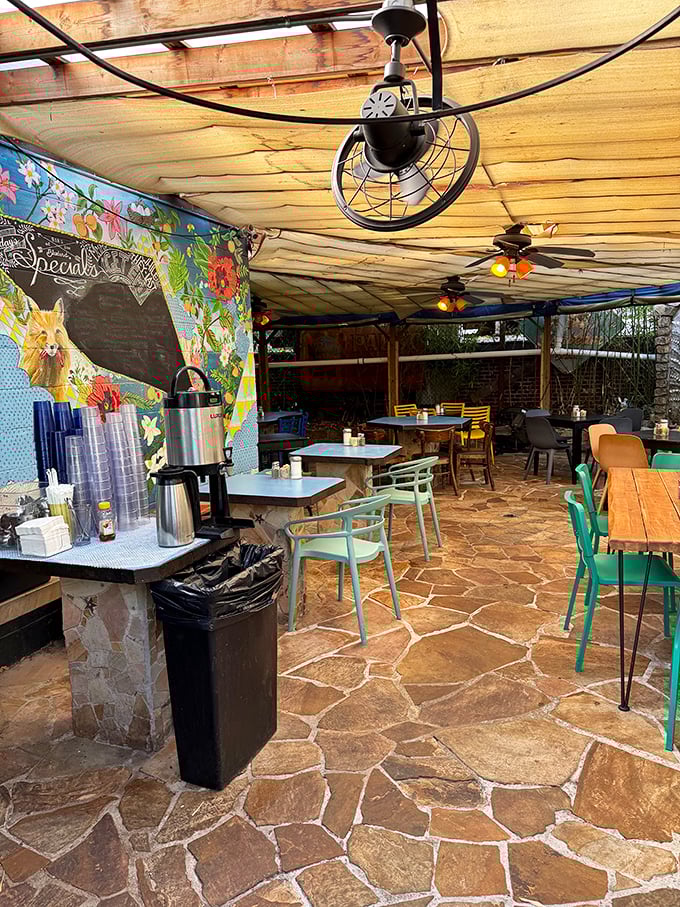 The covered patio offers a bohemian escape with colorful murals, stone flooring, and the promise of leisurely meals under wooden beams.