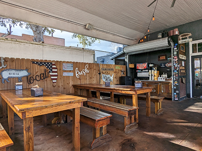 Picnic tables under string lights create that perfect "I've discovered something special" vibe that makes food taste even better.