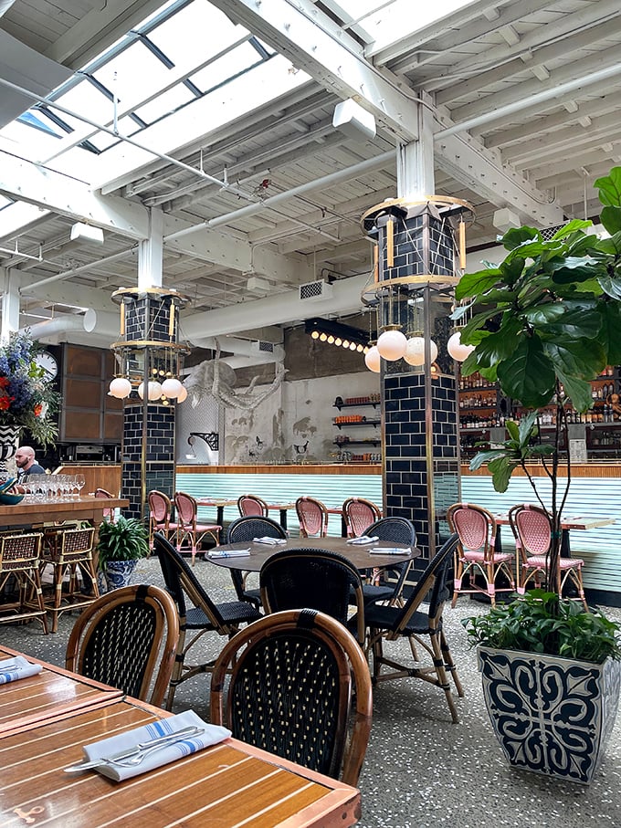 Skylights flood the airy interior with California sunshine, while navy blue columns anchor the space like masts on a luxury liner.