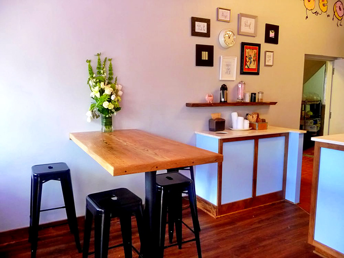 Minimalist interior with wooden tables and artful wall displays creates the perfect backdrop for the real stars&mdash;those incredible vegan donuts.