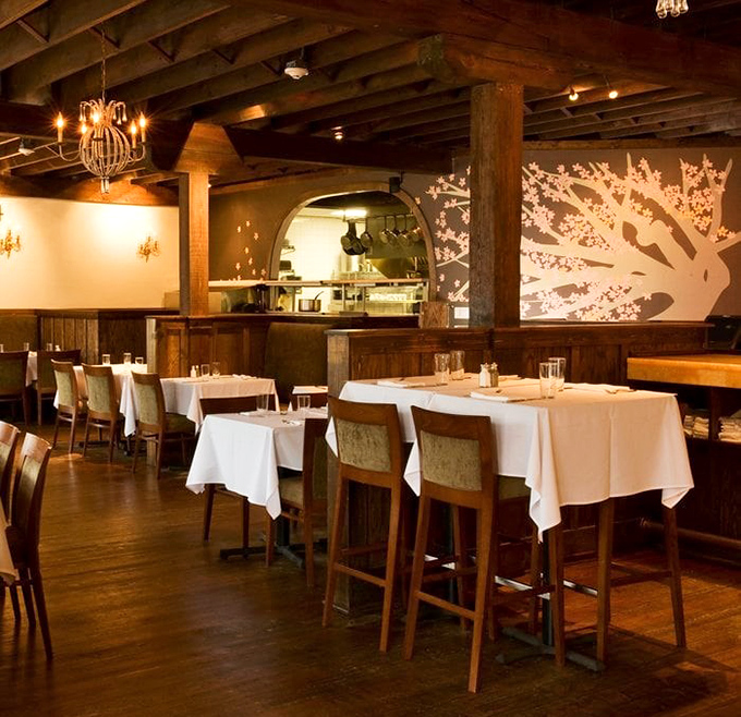 Exposed wooden beams, white tablecloths, and that stunning tree silhouette&mdash;Orsay's dining room manages to be both sophisticated and comfortable, like wearing a tuxedo with slippers.