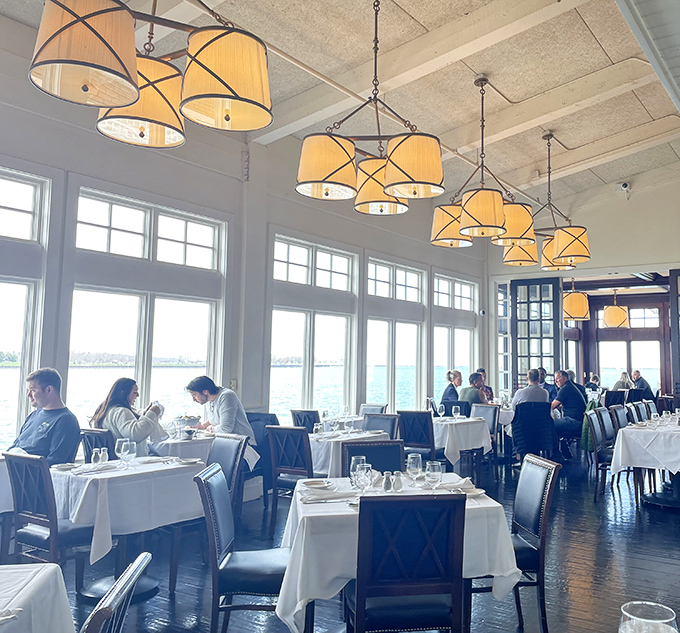 Sunlight streams through floor-to-ceiling windows, turning an ordinary lunch into theater as Lake Michigan plays the scenic backdrop to crisp white tablecloths.