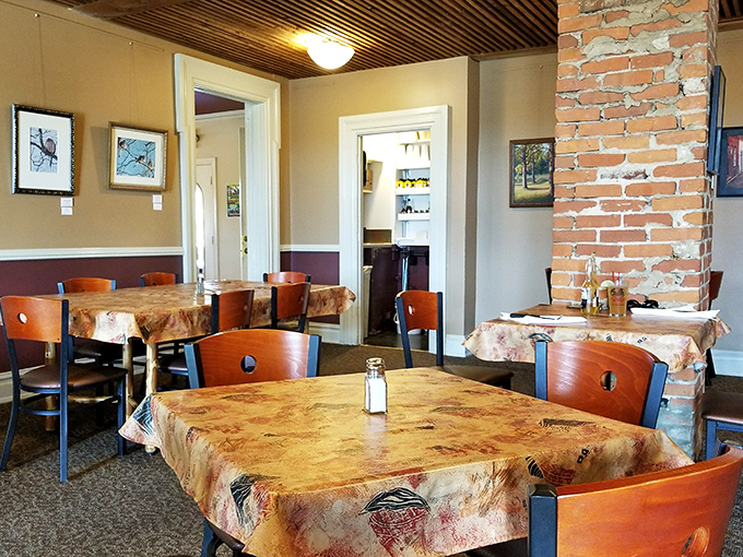 Warm wood chairs, patterned tablecloths, and exposed brick columns create that perfect "grandma's fancy dining room" vibe where comfort meets culinary excellence.
