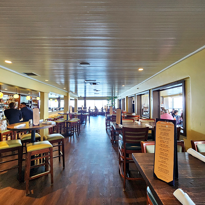 Inside, warm wood tones and nautical touches create the perfect backdrop for ocean-to-table dining. Every seat promises views that would cost extra anywhere else.