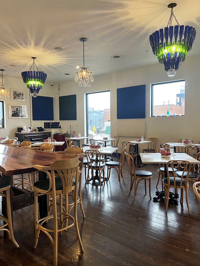 Those blue bottle chandeliers aren't just lighting fixtures&mdash;they're conversation starters that cast magical patterns across DiAnoia's welcoming dining room.