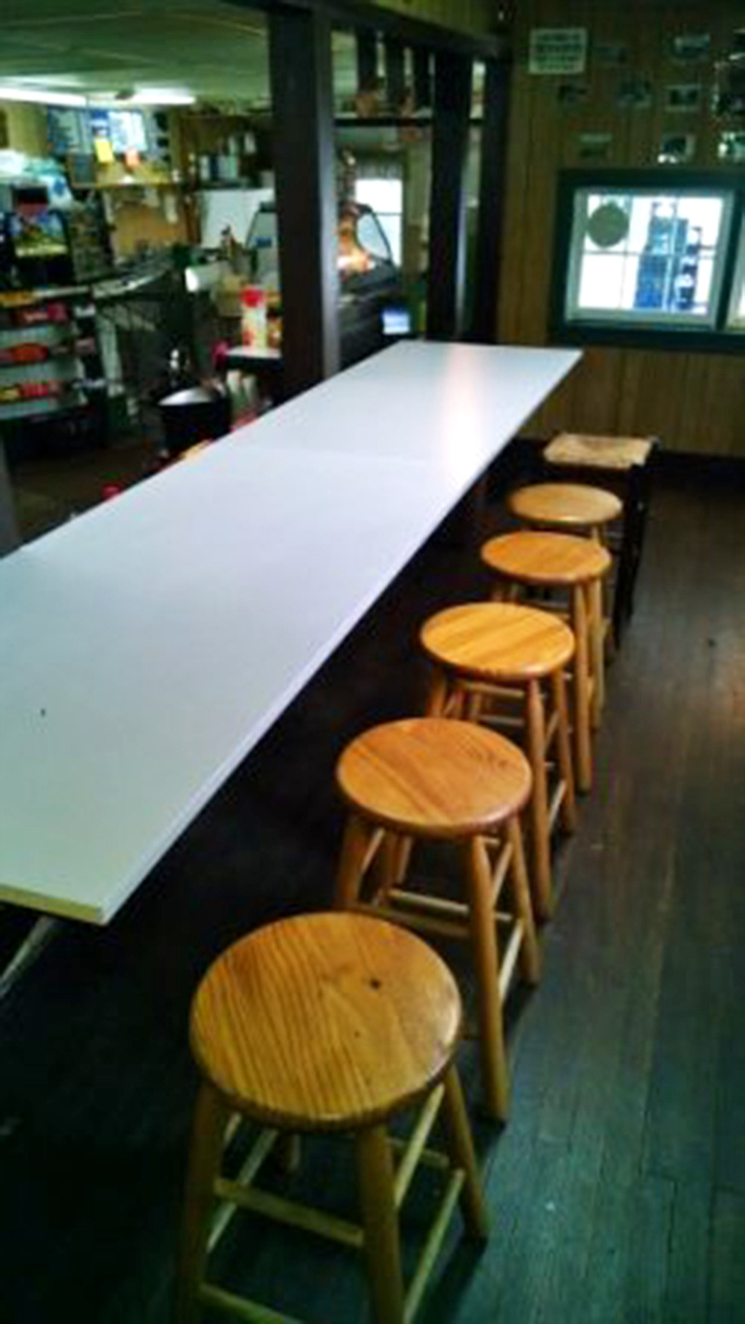 The counter where sandwich magic happens. These wooden stools have witnessed countless "first bite" moments of pure sandwich bliss.