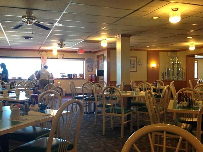 Simple wooden chairs and turquoise tabletops create that perfect small-town diner atmosphere where conversations flow as freely as the coffee.