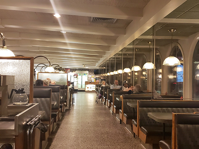 Classic diner ambiance with a touch of elegance &ndash; pendant lights cast a warm glow over booths where countless conversations and comfort food memories have been made.