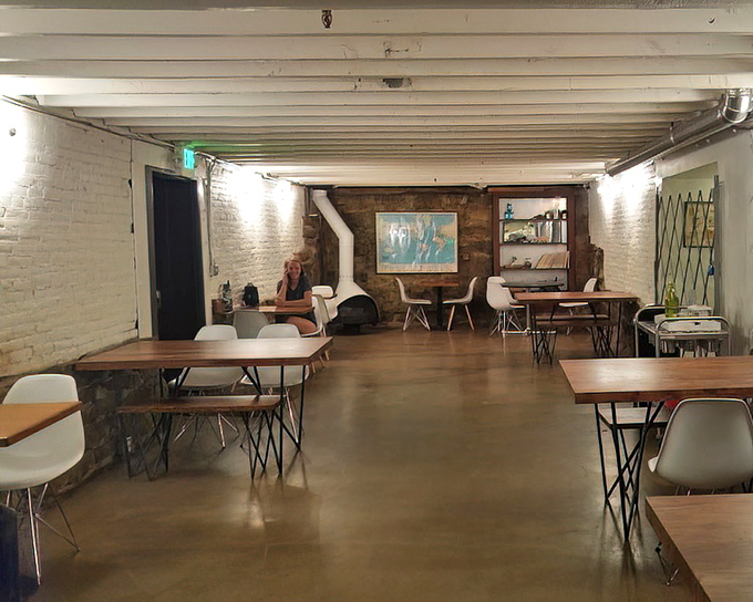 Minimalist chic meets cozy comfort in this airy space where white brick walls and wooden tables create the perfect backdrop for sugar-fueled conversations.