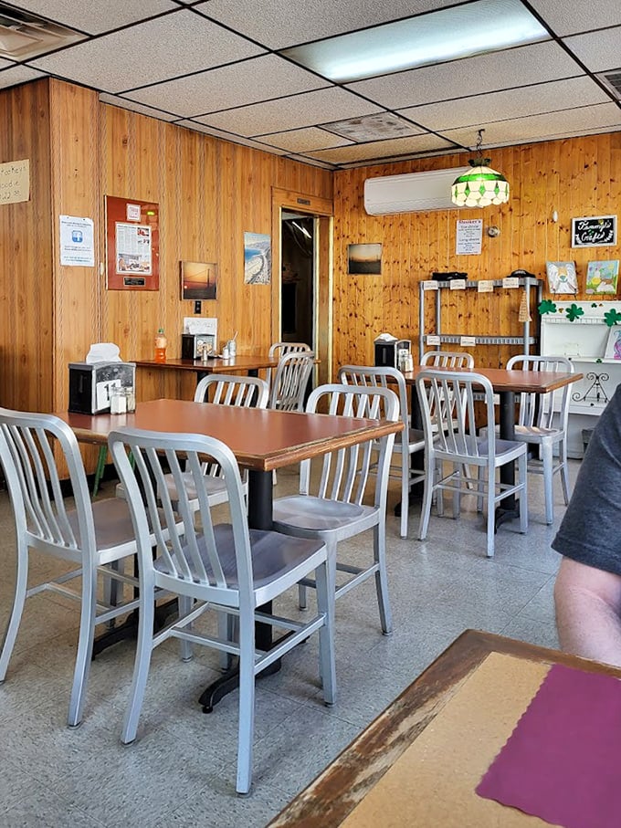Wood-paneled walls and metal chairs tell you everything you need to know—this place spends its energy on the food, not interior decorating. That vintage lamp has seen generations of satisfied smiles.