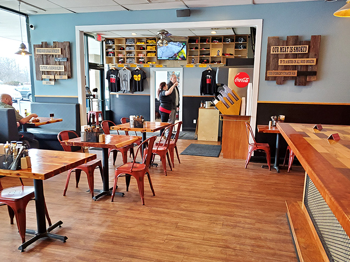 Simple wooden tables, metal chairs, and that "Our Meat Is Smoked" sign &ndash; because sometimes the most important truths need to be displayed on the wall.