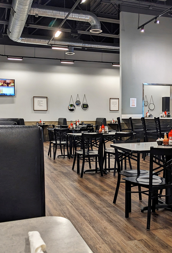 Clean lines, exposed ductwork, and comfortable seating create the perfect canvas for breakfast artistry. Your stomach is already sending thank-you notes.