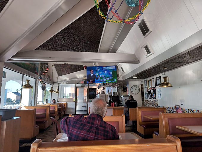 Inside, wooden booths worn smooth by decades of satisfied customers create the perfect setting for burger bliss.