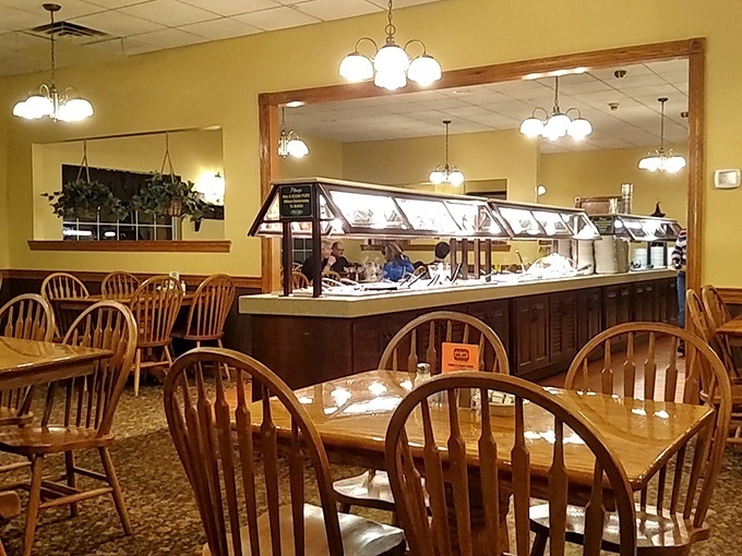 Windsor chairs and warm lighting create that "grandma's dining room for 100" vibe that tells you comfort food greatness awaits.