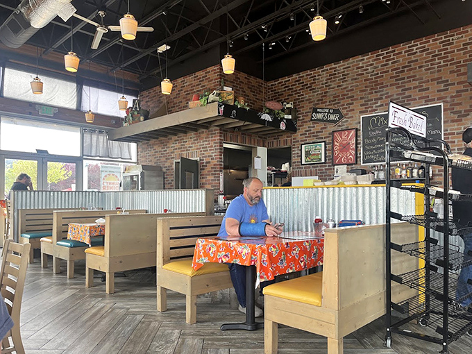 Inside, wooden booths and exposed brick create that perfect "third place" where strangers become regulars and calories don't count before noon.