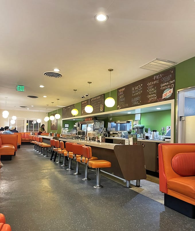 Classic orange booths and counter seating create the perfect backdrop for life-changing breakfast conversations and burger epiphanies.