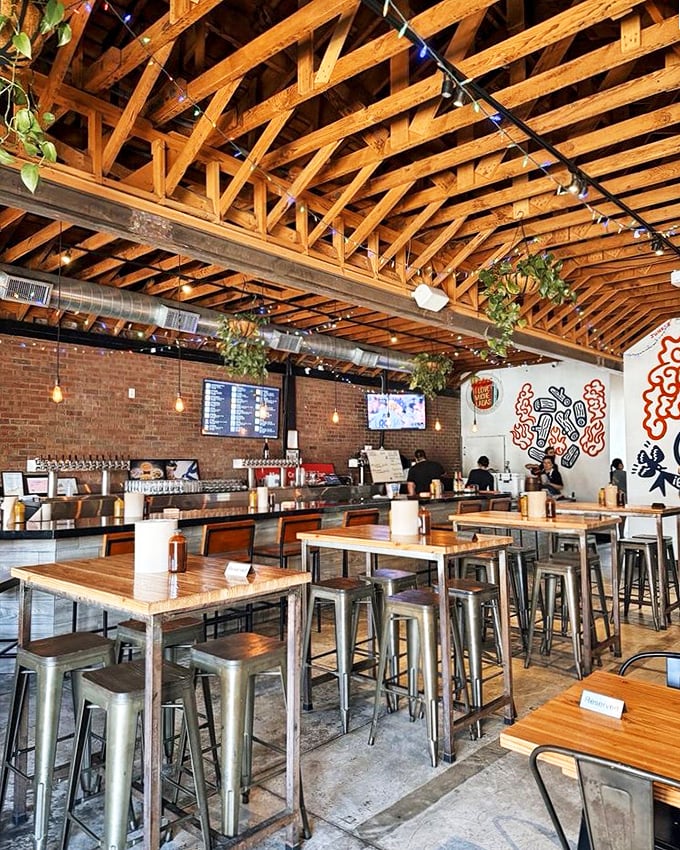 Exposed wooden beams, brick walls, and the promise of smoked perfection. The interior at Moo's combines industrial chic with barbecue functionality.