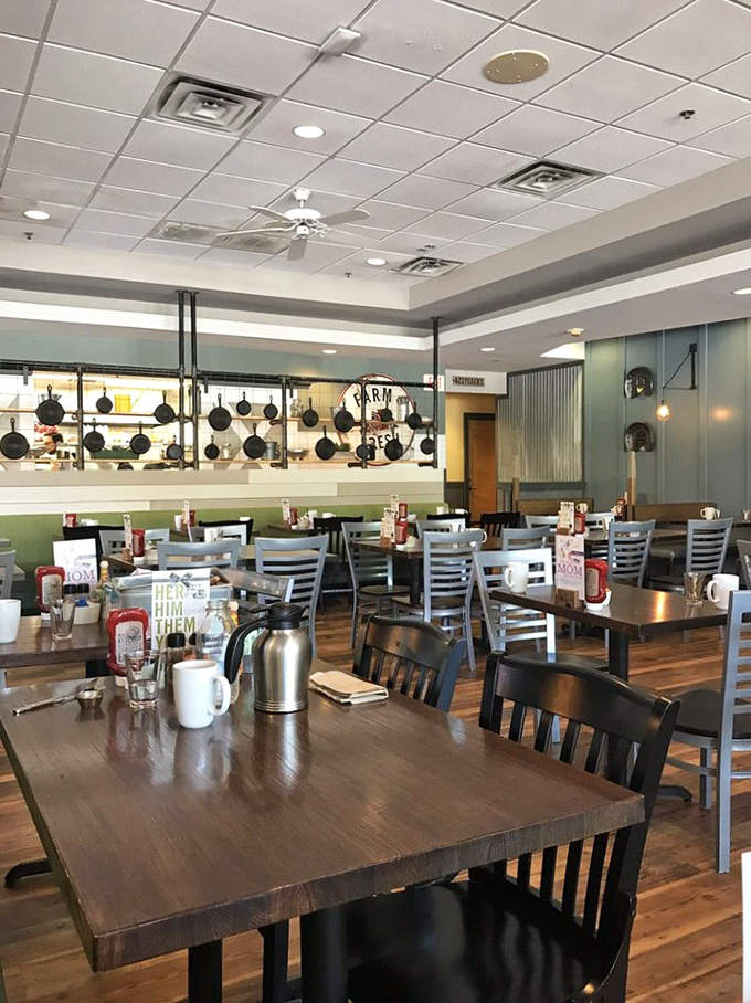 The warm wood tones and hanging pots create an atmosphere that says "we're serious about breakfast" without any unnecessary fuss.