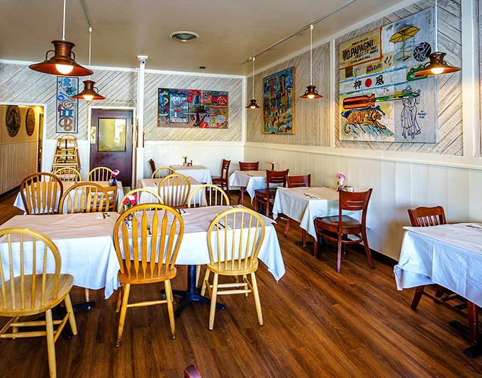 Wooden chairs and white tablecloths create that perfect "I'm-on-vacation-but-also-at-grandma's" vibe. Colorful local art tells stories while you dine.