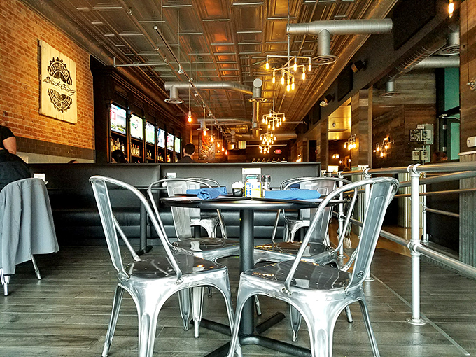 Industrial chic meets maritime comfort inside, where metal chairs and exposed brick set the stage for oceanic delights.