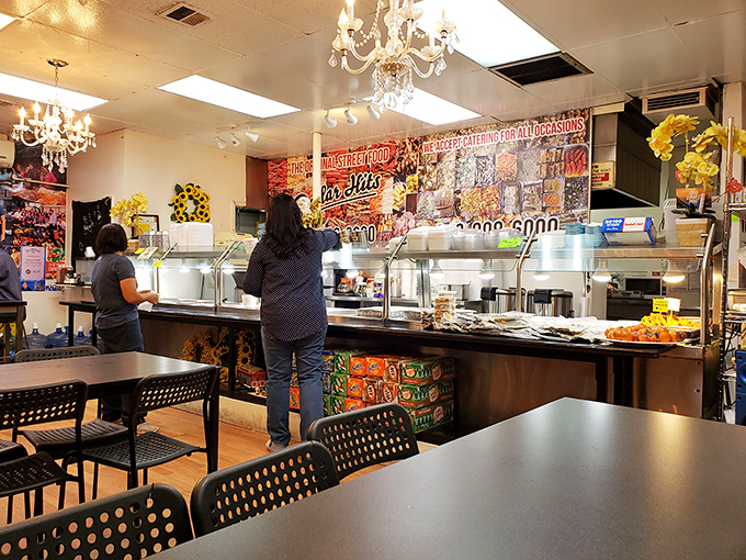 Crystal chandeliers hanging above a cafeteria-style counter? It's like your grandmother's formal dining room collided with a street food paradise.