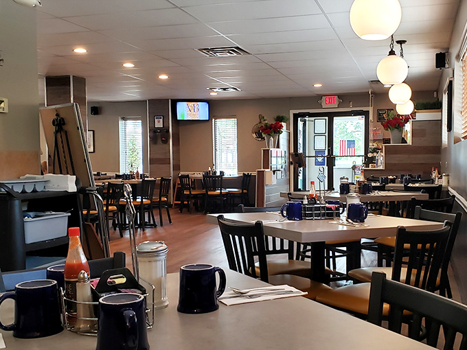 Inside, globe lights cast a warm glow over blue mugs and wooden chairs—the universal language of "sit down, stay awhile."