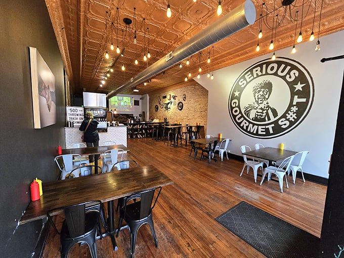 Step inside and the copper-toned tin ceiling, Edison bulbs, and that "Serious Gourmet" mural let you know &ndash; these folks aren't playing around with your burger experience.