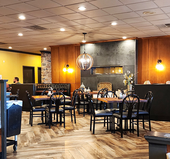 Warm wood paneling meets modern touches in this dining room that feels like home, if home had better lighting and someone else doing the dishes.