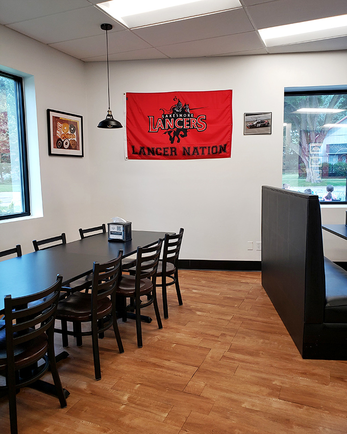 Local pride shines through with the Lancer Nation flag, where wooden floors and simple tables create the perfect stage for donut magic.
