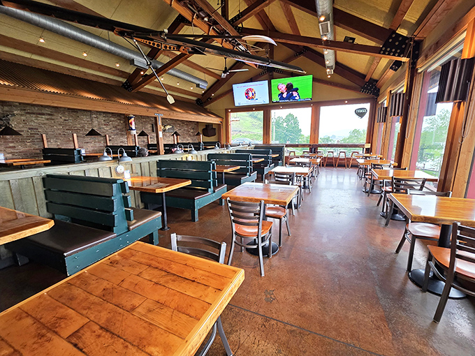 Rustic wooden beams and stone walls create the perfect backdrop for BBQ communion. The cathedral-like space elevates pulled pork to a religious experience.