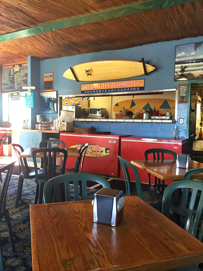 Surfboards don't lie&mdash;this interior screams "California beach culture" with its wooden tables, blue walls, and that cheeky "We Have The Technology" sign above the kitchen.