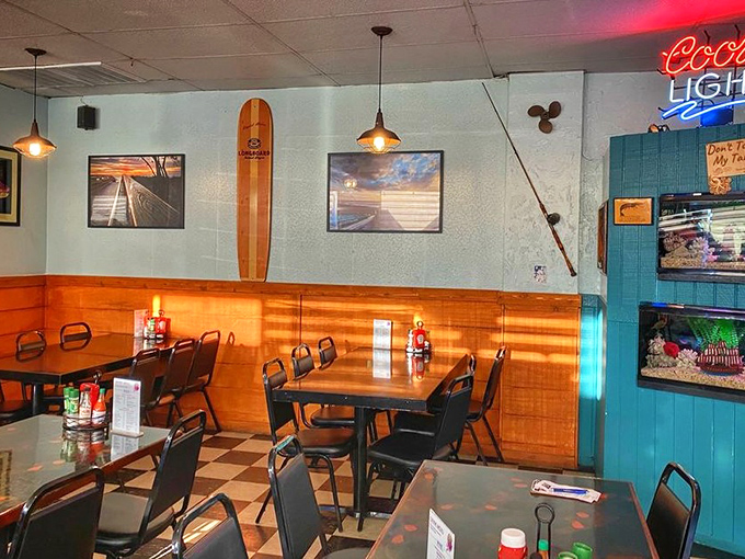 Beach-chic meets old Florida charm with that surfboard on the wall. The checkerboard floor says "we've been here a while" in the best possible way. 
