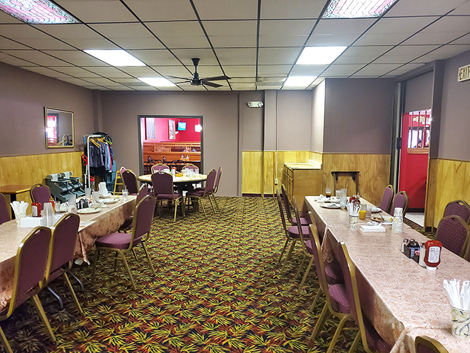 Step inside and time slows down &ndash; wood paneling, burgundy chairs, and a carpet pattern that screams "authentic diner experience" in the most comforting way possible.