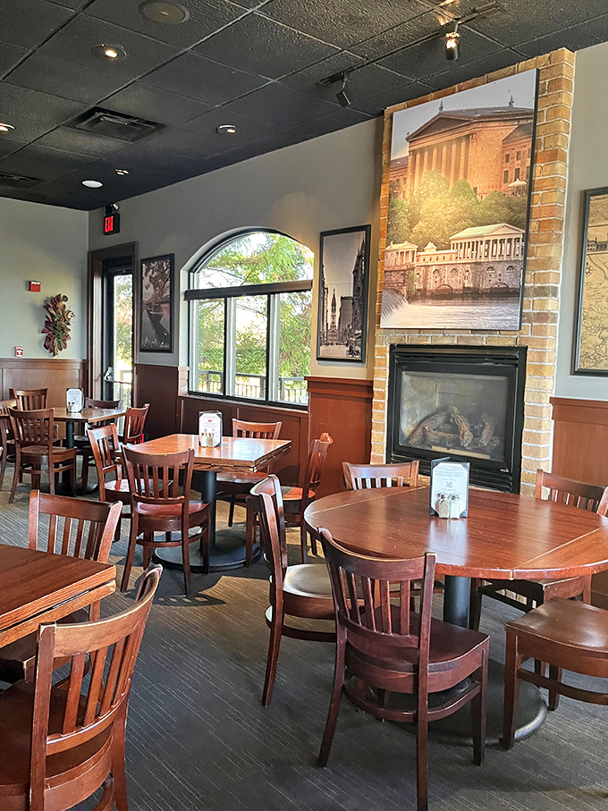 Warm wood tones, brick accents, and a cozy fireplace create the perfect backdrop for comfort food conversations. Philadelphia's art museum watches approvingly from the wall.