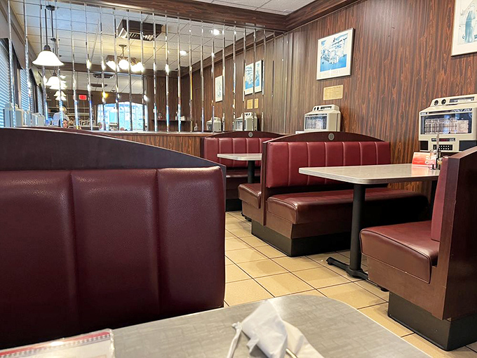 Classic burgundy booths invite you to slide in and stay awhile. Wood paneling and cozy seating&mdash;diner design that's stood the test of time.