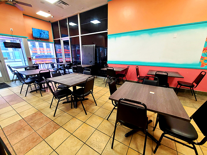 Vibrant coral walls and teal accents create a dining space that's as cheerful as finding an extra onion ring in your fries.