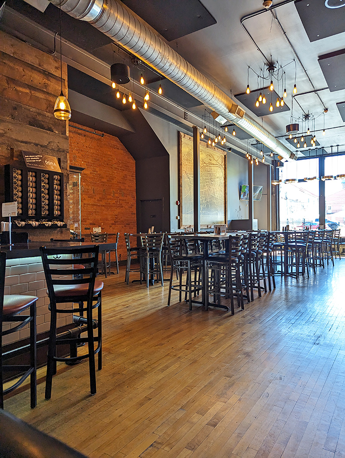 Industrial meets inviting inside The Pour House, where exposed brick, wooden floors, and Edison bulbs create an atmosphere that whispers, "Stay awhile, friend."