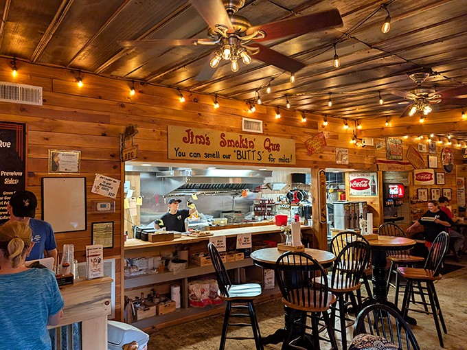 Step inside and the warm glow of string lights illuminates a wood-paneled sanctuary where BBQ dreams come true and diet plans go to die.