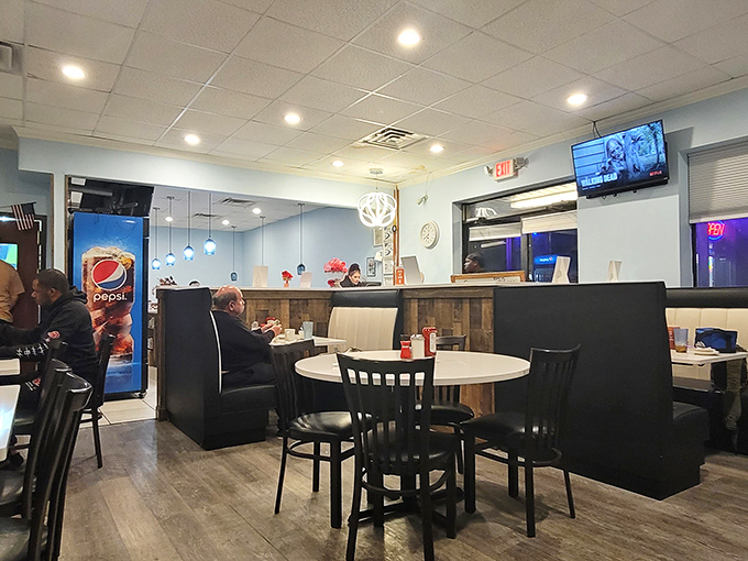 Inside, wood-paneled walls and comfortable booths create that perfect diner atmosphere where strangers become friends and coffee cups never empty.