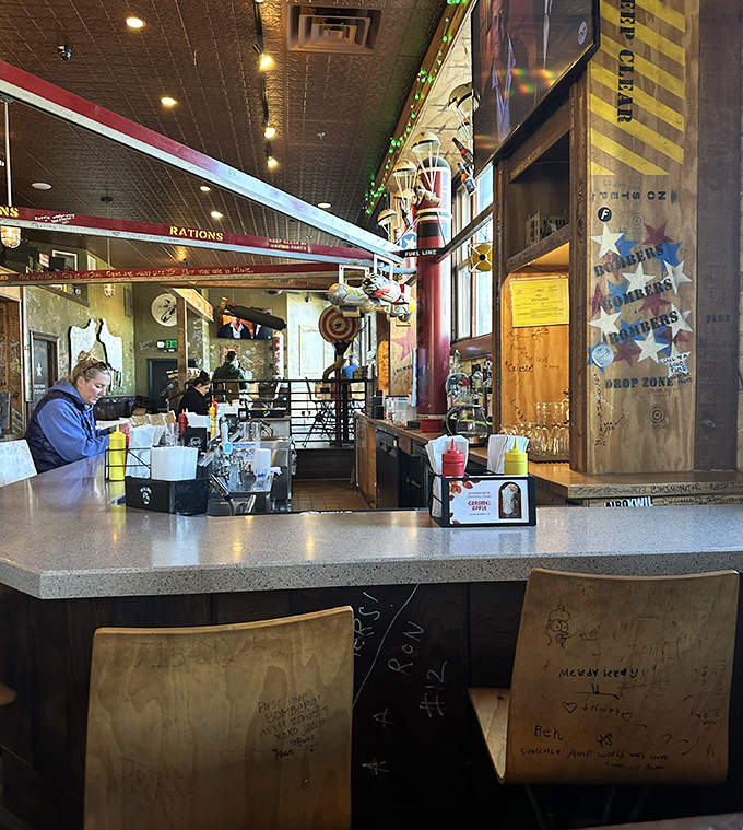 Inside, aviation-themed whimsy meets burger joint practicality. Those tracks on the ceiling? They're not just decoration&mdash;they're peanut delivery systems!