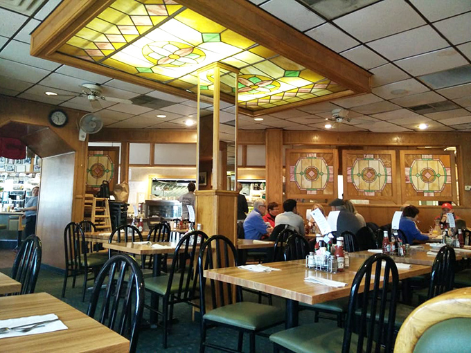 Stained glass ceiling fixtures cast a warm glow over wooden booths where breakfast dreams come true. This isn't trendy design&mdash;it's the comfort of tradition.