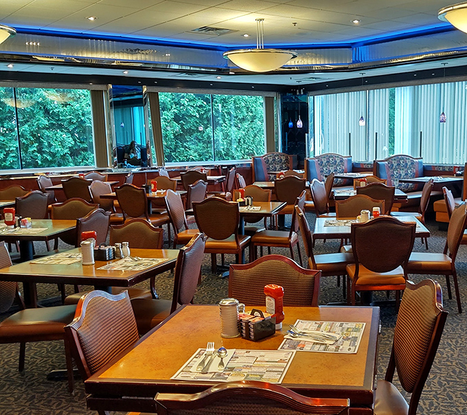 Step inside where blue accent lighting and cozy booths create the perfect breakfast sanctuary experience.