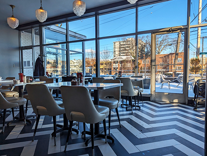That chevron floor isn't messing around! The interior's floor-to-ceiling windows flood the space with natural light, making every dish look like it's ready for its close-up.