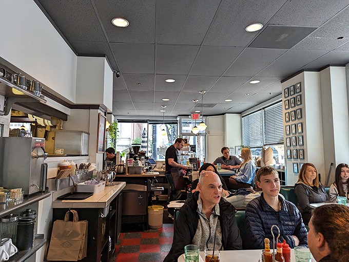 The bustling interior reveals the secret to this place's success: happy diners, checkered floors, and that unmistakable neighborhood vibe.