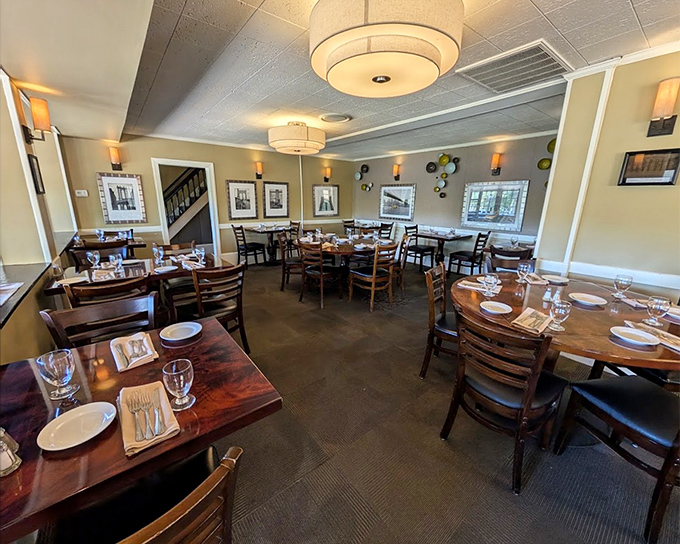 Rich wood tables and warm lighting create the perfect setting for memorable conversations over exceptional meals.