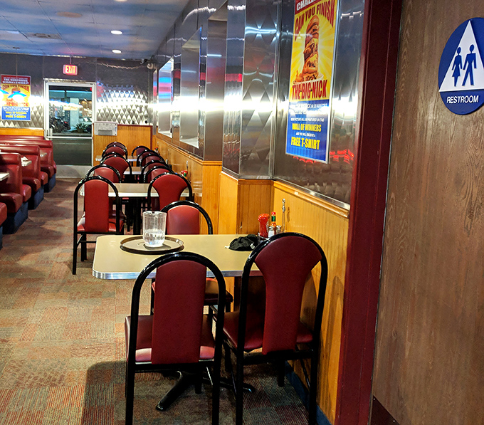 Classic red vinyl booths and chrome accents—where conversations flow as freely as the coffee. Diner perfection in every detail.